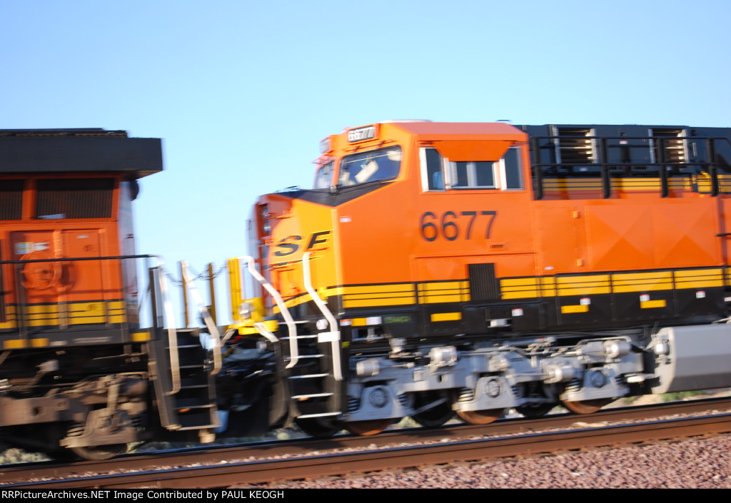 BNSF 6677 Zips by me doing over 60 MPH as she heads into a Beautiful Barstow California Sunrise ...